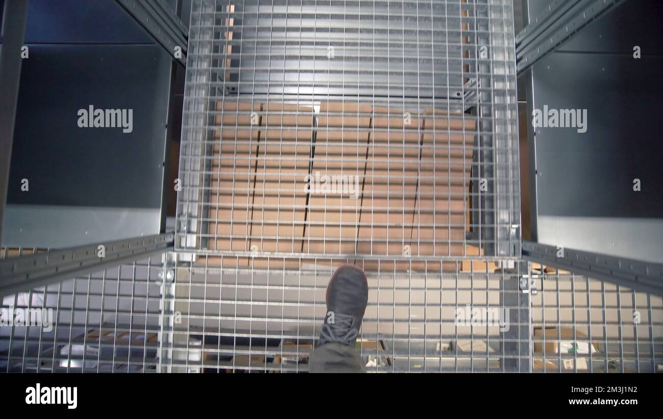 Man walks on stairs in warehouse. Creative. Close-up of man walking ...