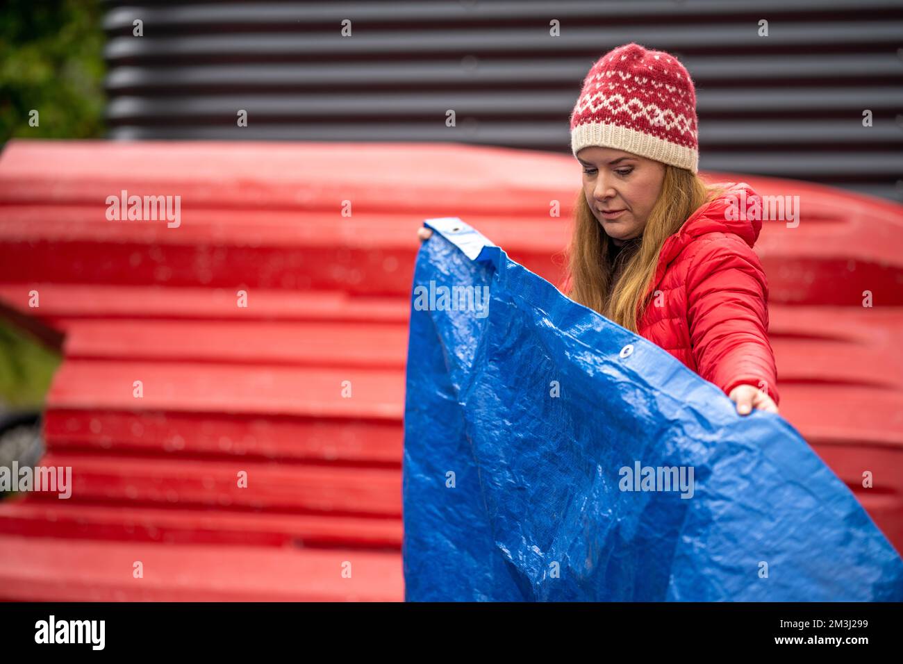 folding up a blue tarp after camping at a music festival in australia ...