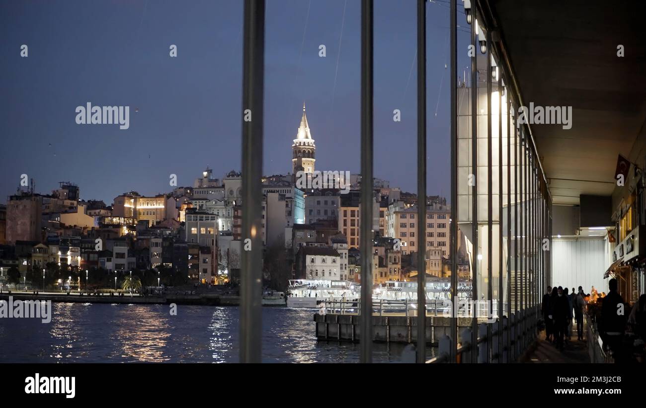 View through window on a coastal town lights and rippling water. Action ...