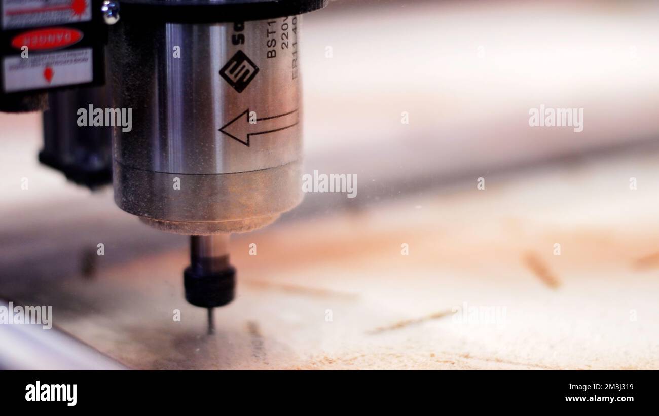 Concept of production and woodworking. Motion. Cutting wood with a CNC ...