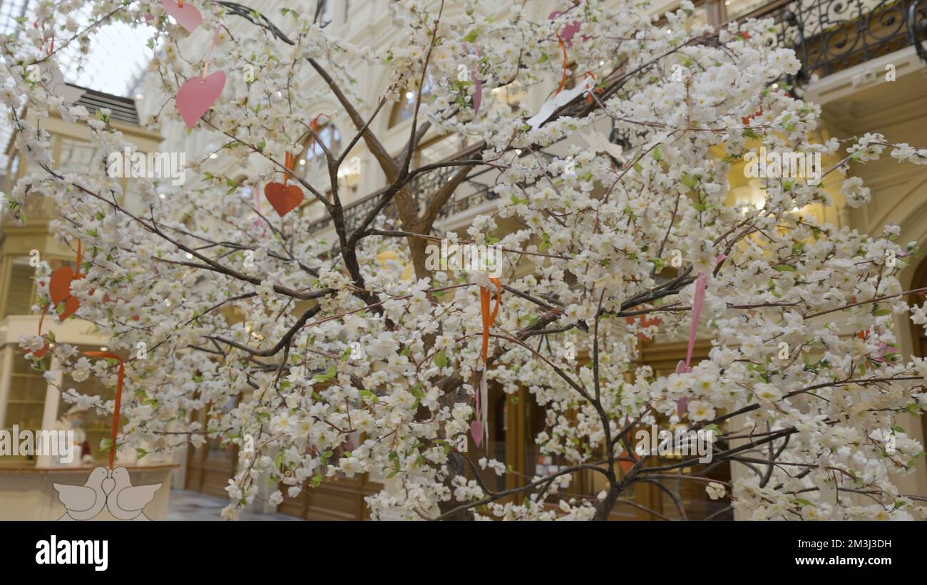 Close up of beautiful blooming artificial tree in a shopping center ...