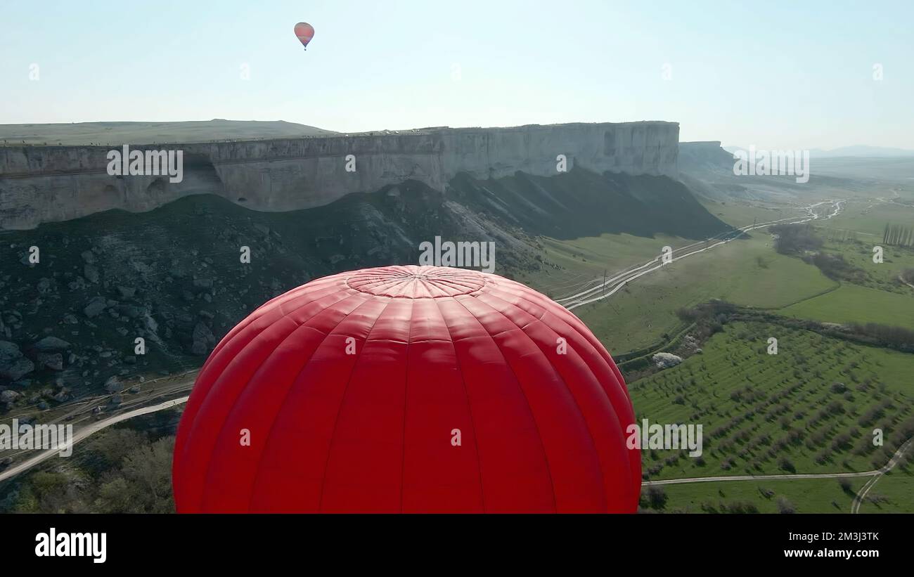Top view of balloon at dawn with rock. Shot. Summer balloon festival at ...