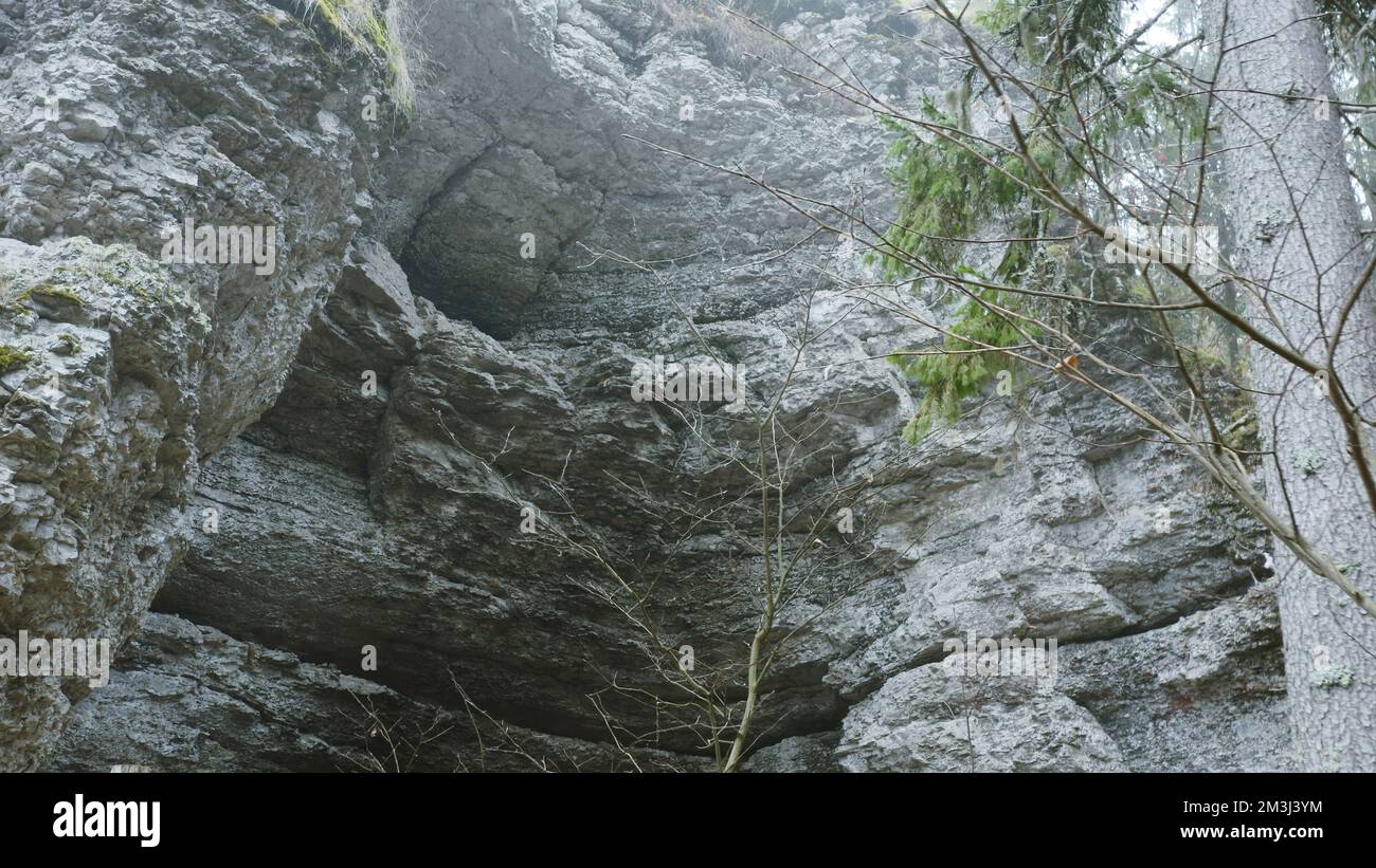 Stone cliff with cave entrance at top. Clip. Top view of stone wall ...