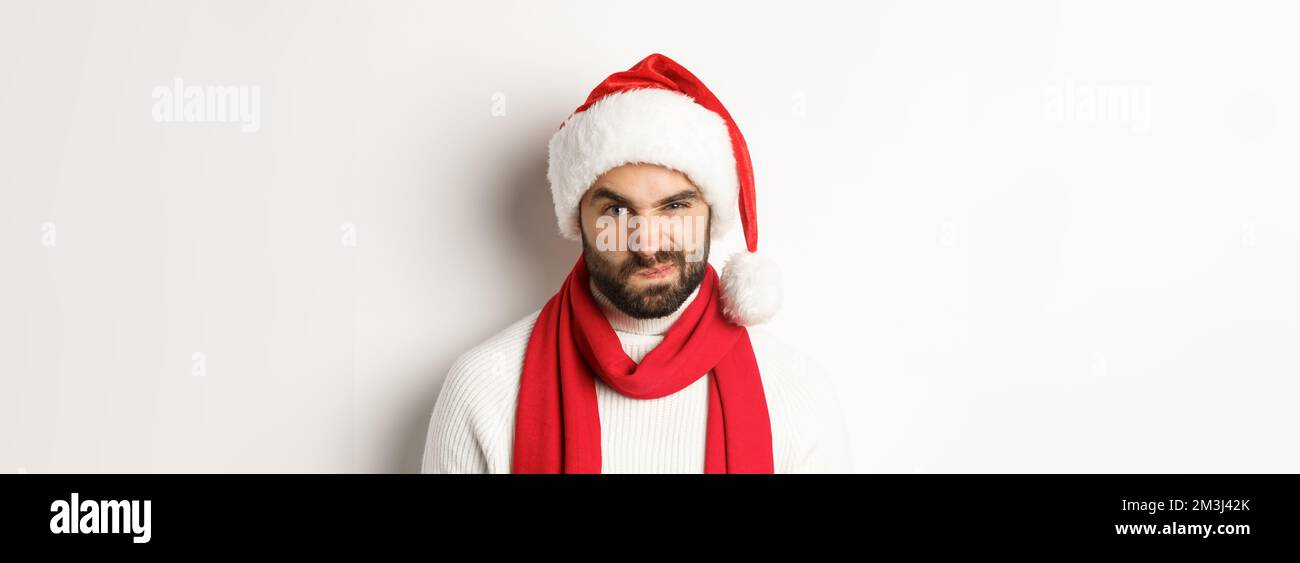 New Year party and winter holidays concept. Close-up of grumpy guy in ...