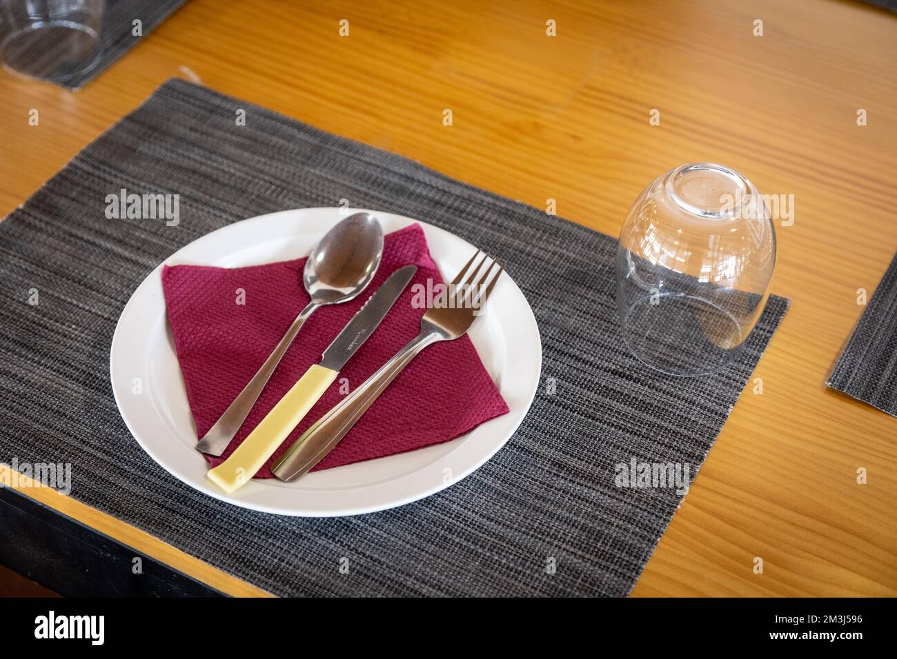 A closeup shot of a wooden table decorated with a beautiful table set ...
