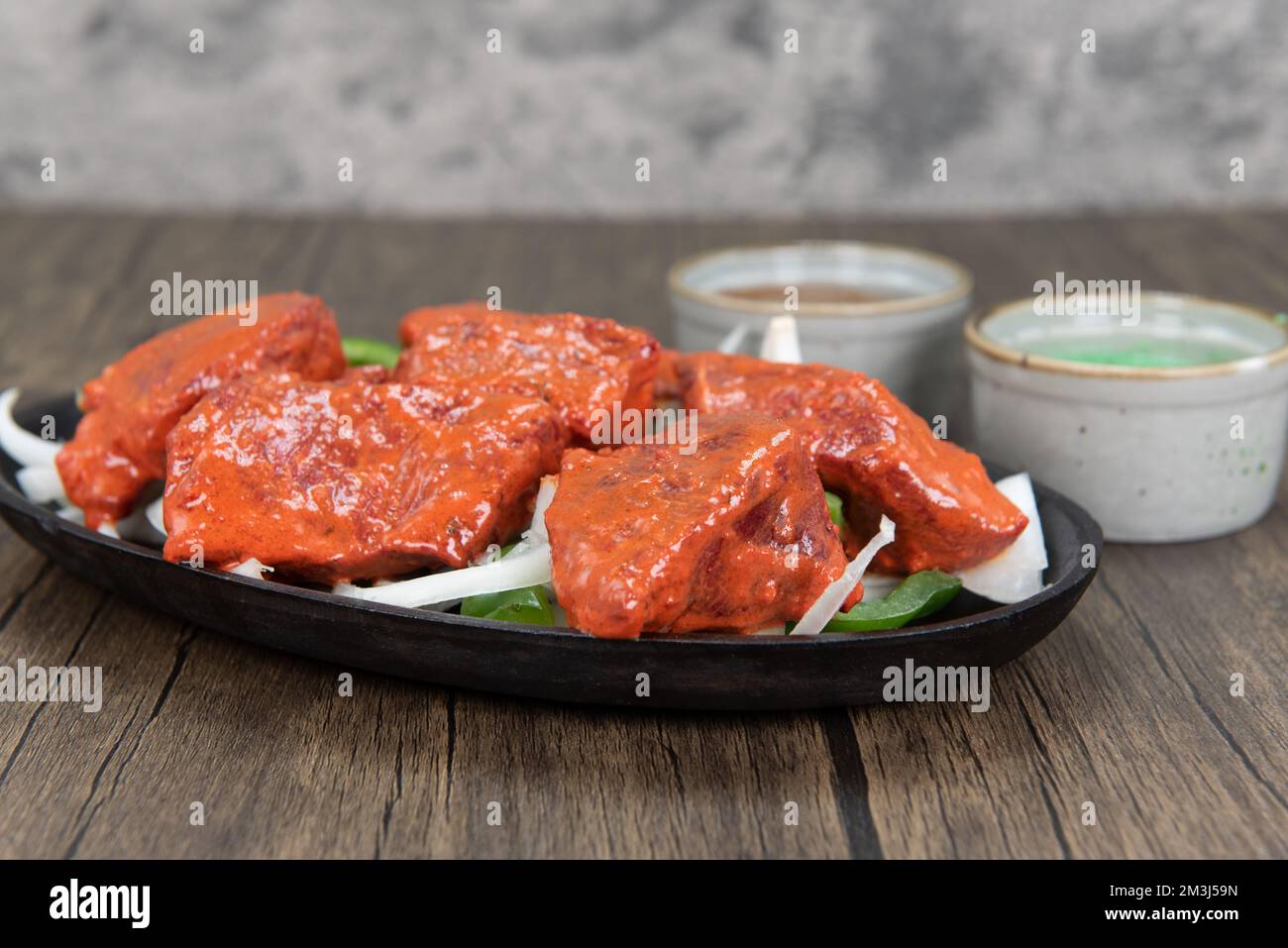 Generous portions of lamb boti kabab meat served over a bed of onions ...