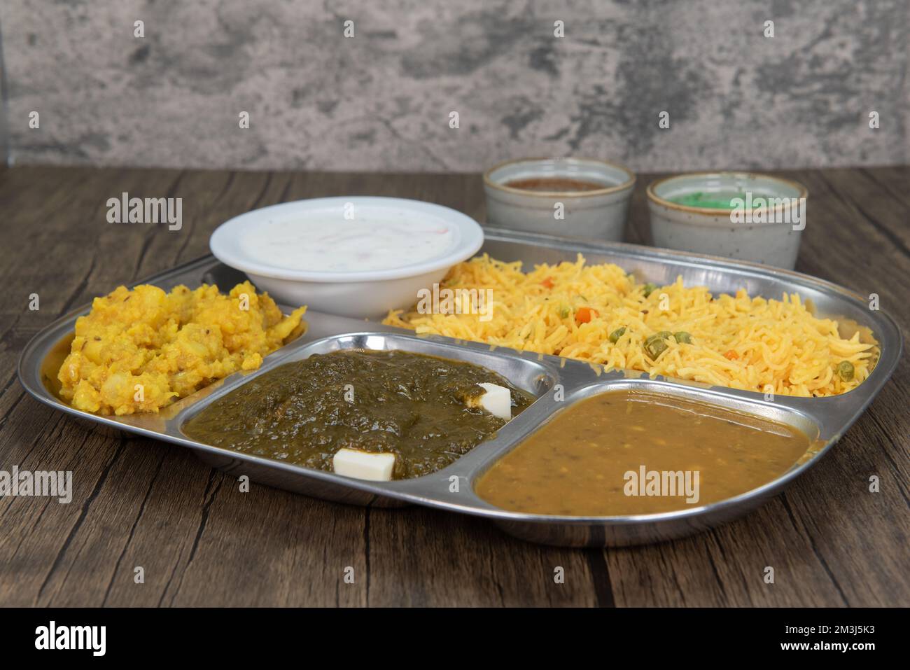 Traditional Indian meal in a partitioned tray with all the vegetarian ...