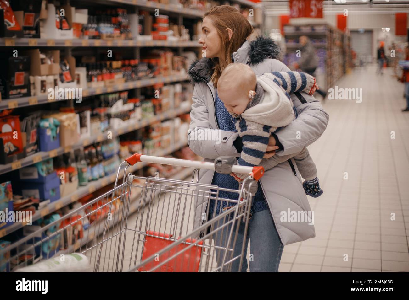 Shopping with kids. Mother and child buying in supermarket. Mom and her ...