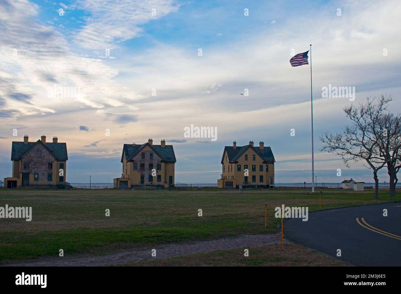 Officer's row quarters at Sandy Hook Bay, viewed during a cloudy sunset ...