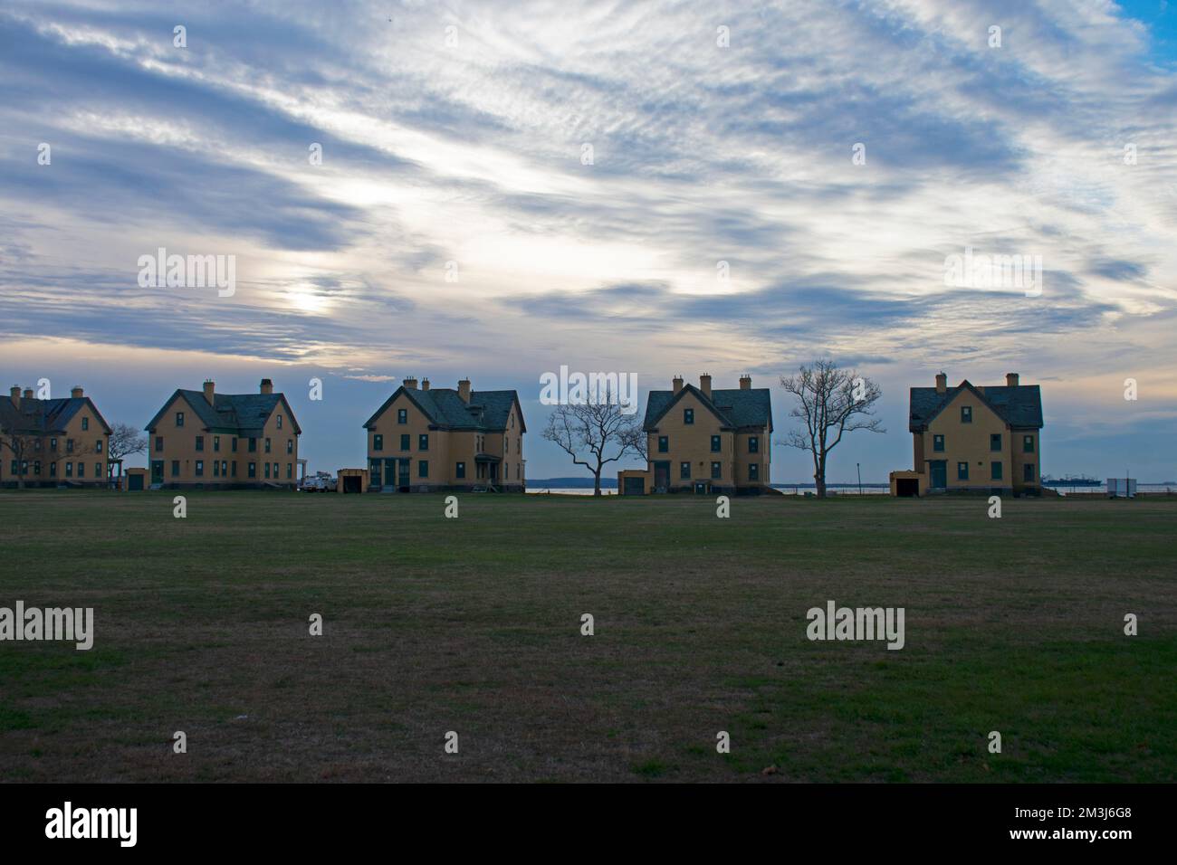 Officer's row quarters at Sandy Hook Bay, viewed during a cloudy sunset ...