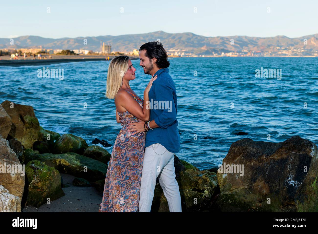 A cute couple looking into each others eyes lovingly on the beach Stock ...
