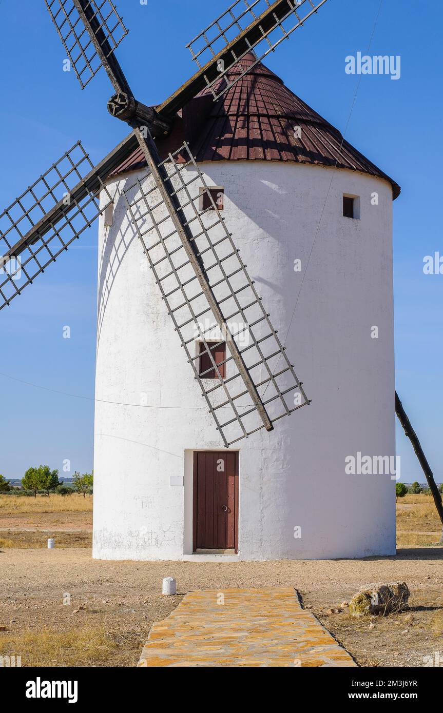 A vertical shot of a medieval windmill on a blue sky background - Spain ...