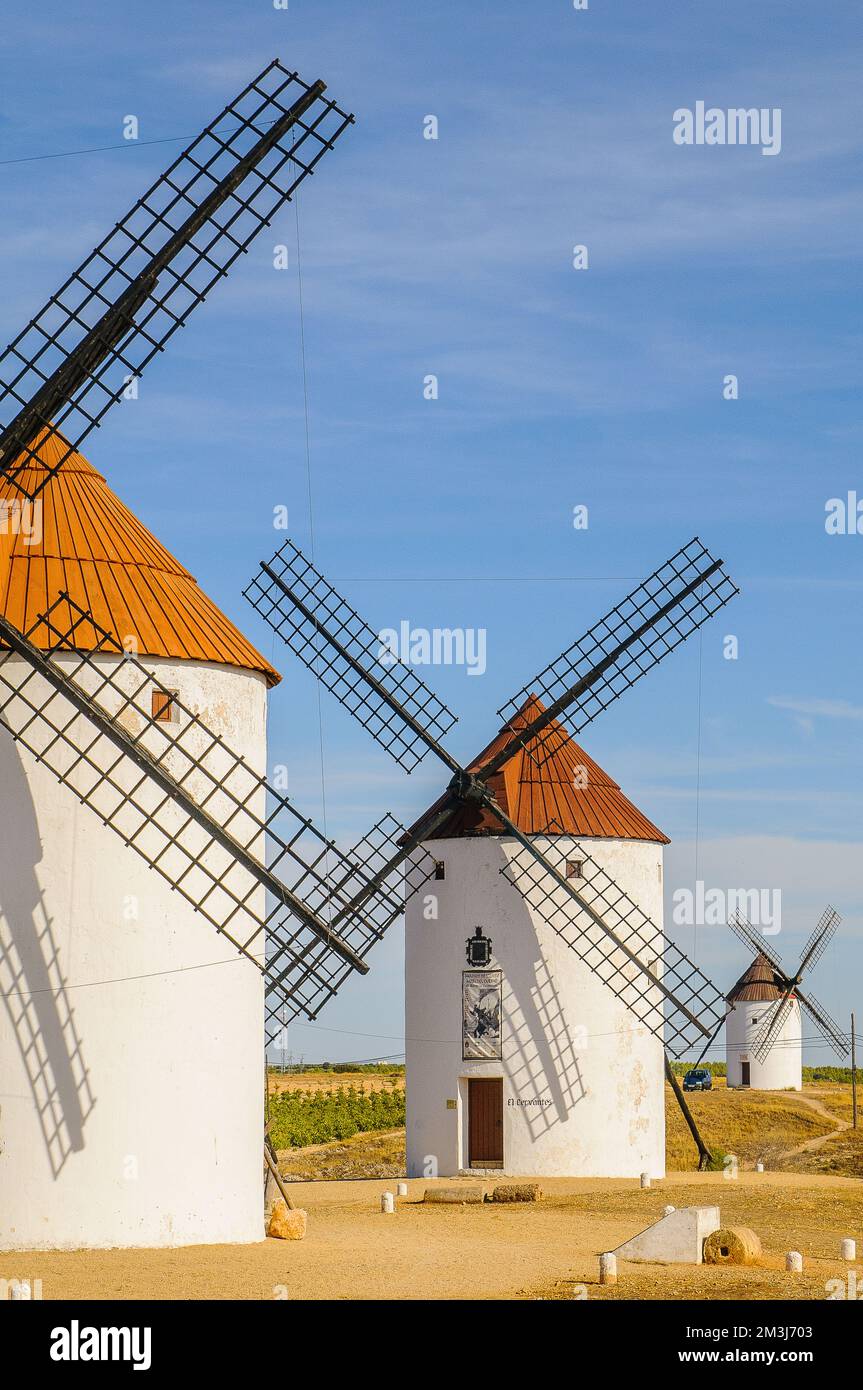 A vertical shot of medieval windmills on a blue sky background - Spain ...