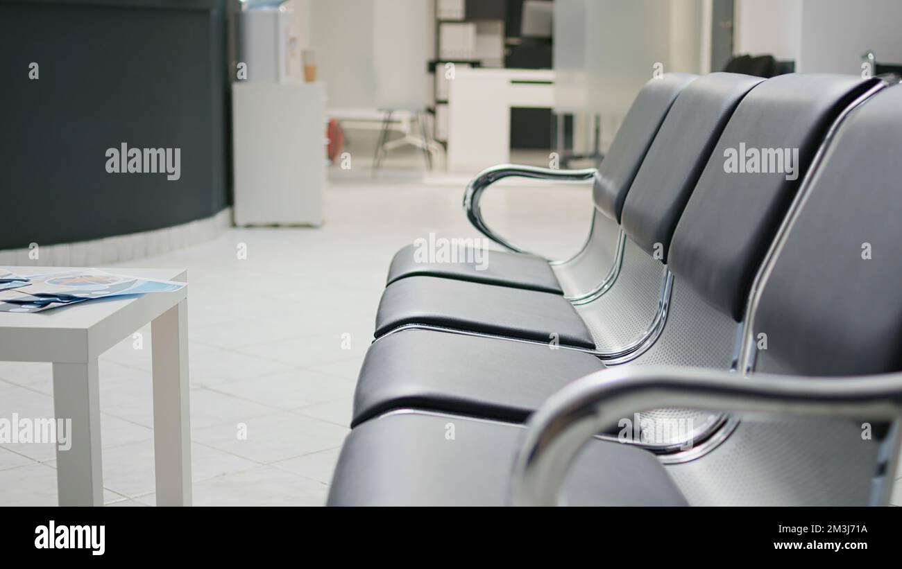 Clinical waiting area with seats in facility lobby, reception counter ...