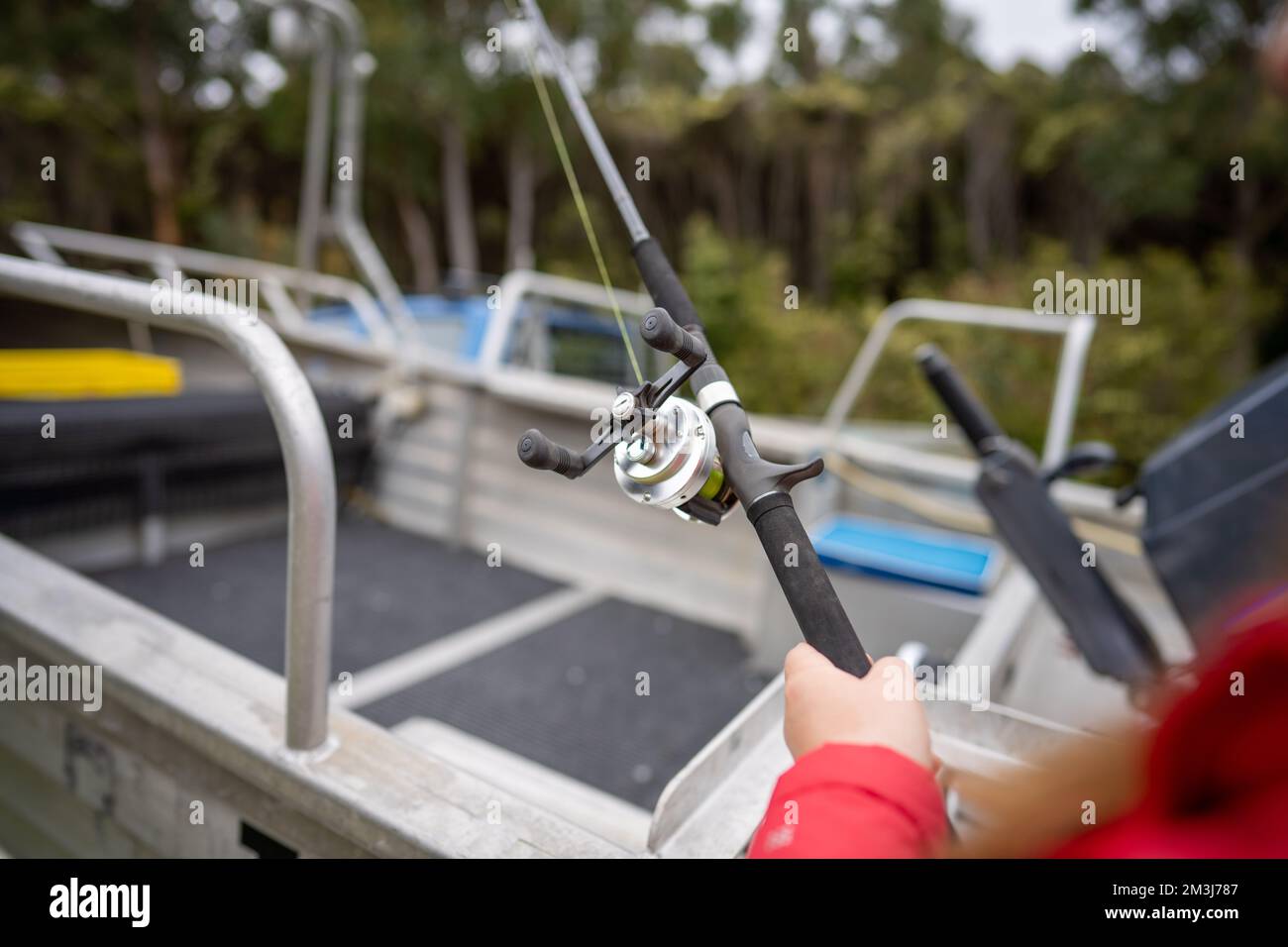 model girl fishing in a boat in summer in australia Stock Photo - Alamy