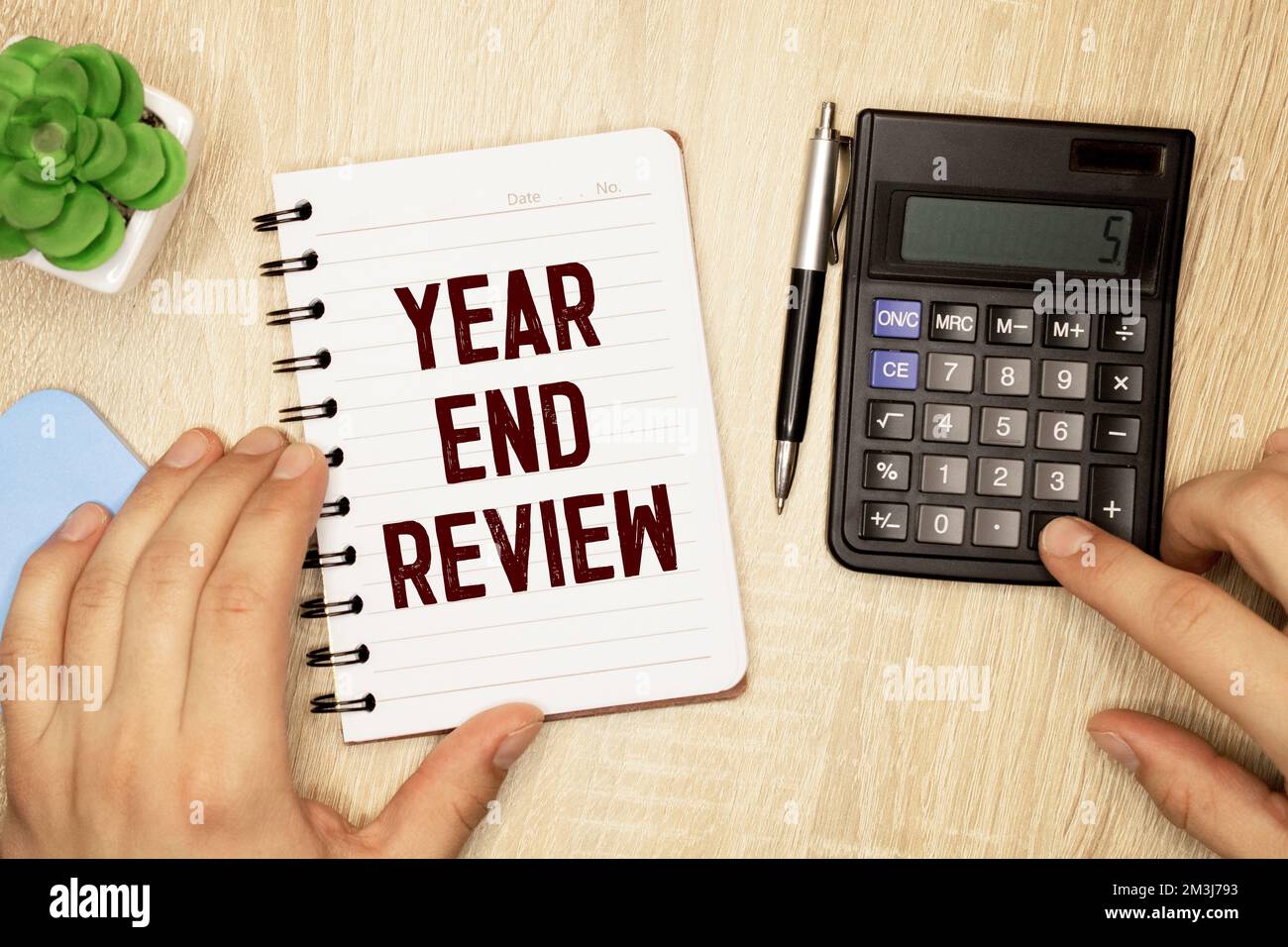 Business concept.Text YEAR END REVIEW on paper note with calculator ...