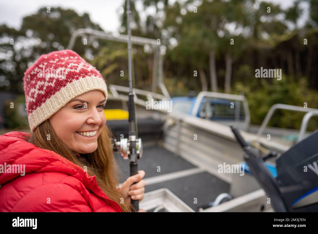 model girl fishing in a boat in summer in australia Stock Photo - Alamy