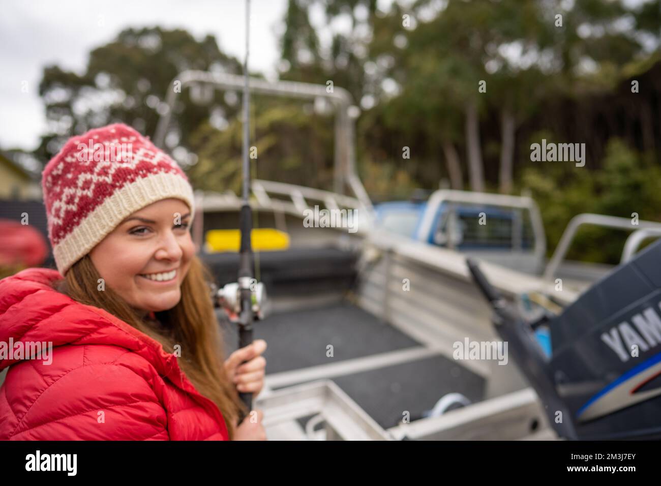 model girl fishing in a boat in summer in australia Stock Photo - Alamy