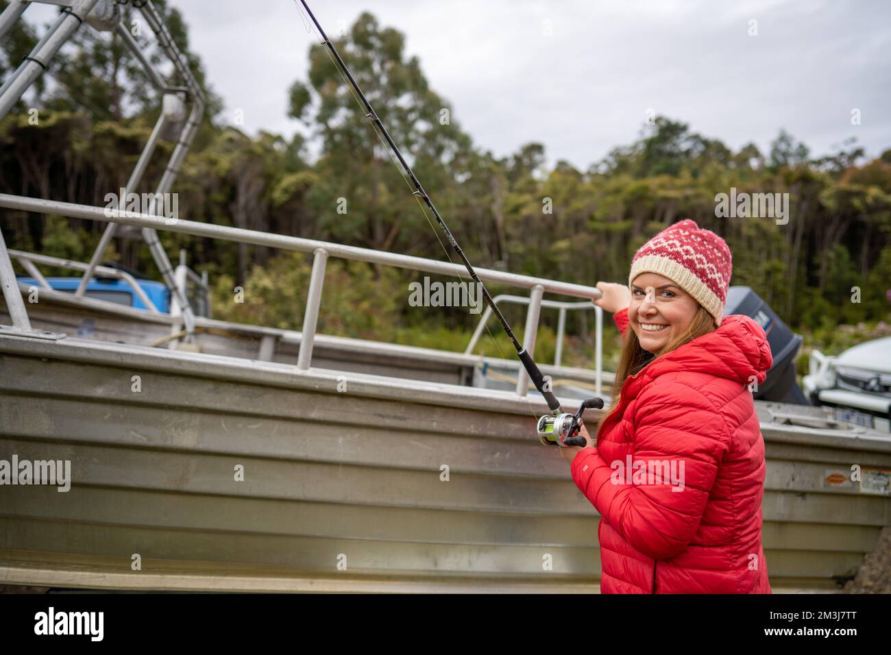 model girl fishing in a boat in summer in australia Stock Photo - Alamy