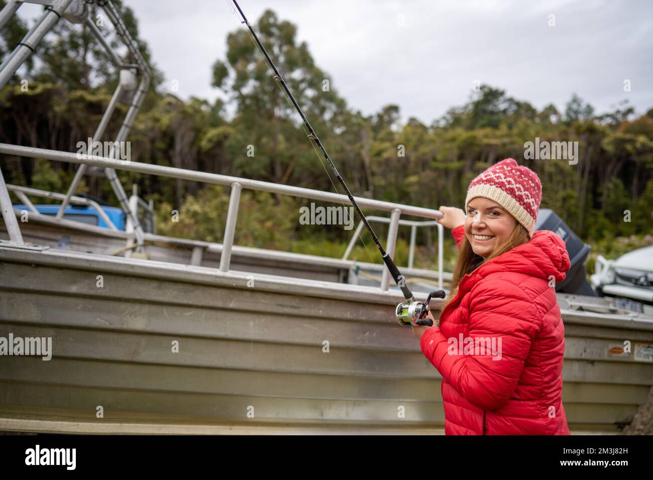 model girl fishing in a boat in summer in australia Stock Photo - Alamy