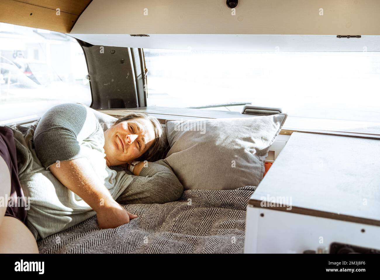 Young 30s caucasian woman with dark hair laying in a self converted ...