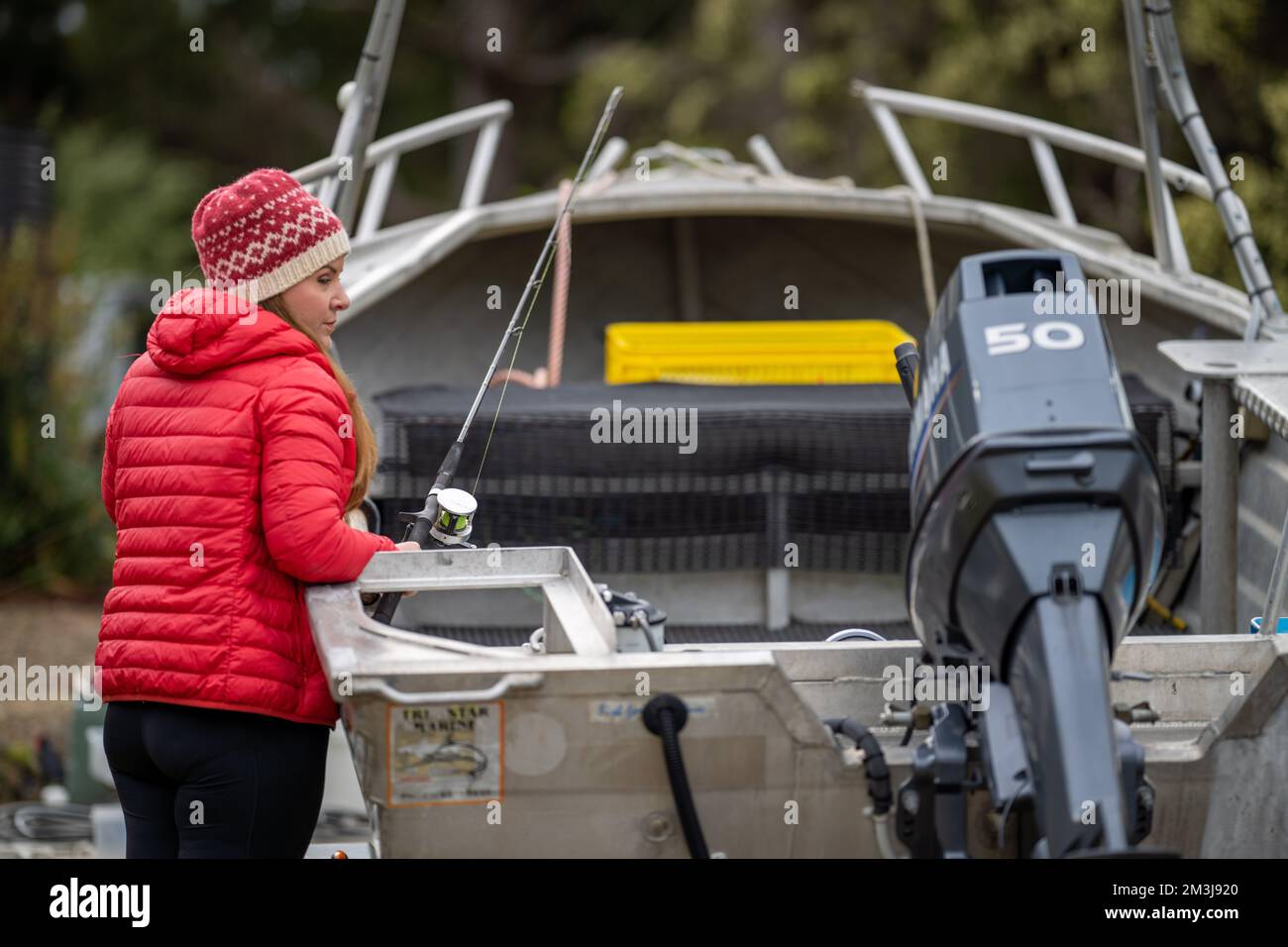 model girl fishing in a boat in summer in australia Stock Photo - Alamy