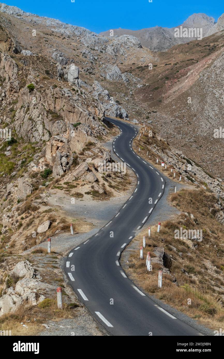 A vertical shot of a curving highway across the mountains Stock Photo ...