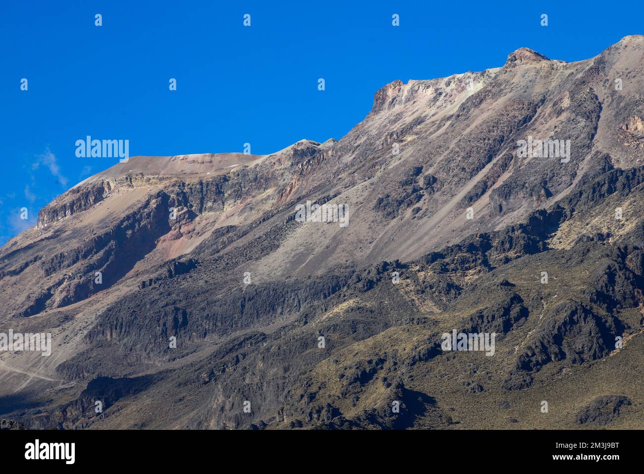 A mountain with no vegetation on blue sky background Stock Photo - Alamy