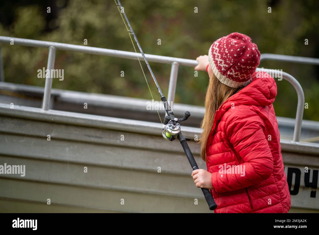 model girl fishing in a boat in summer in australia Stock Photo - Alamy