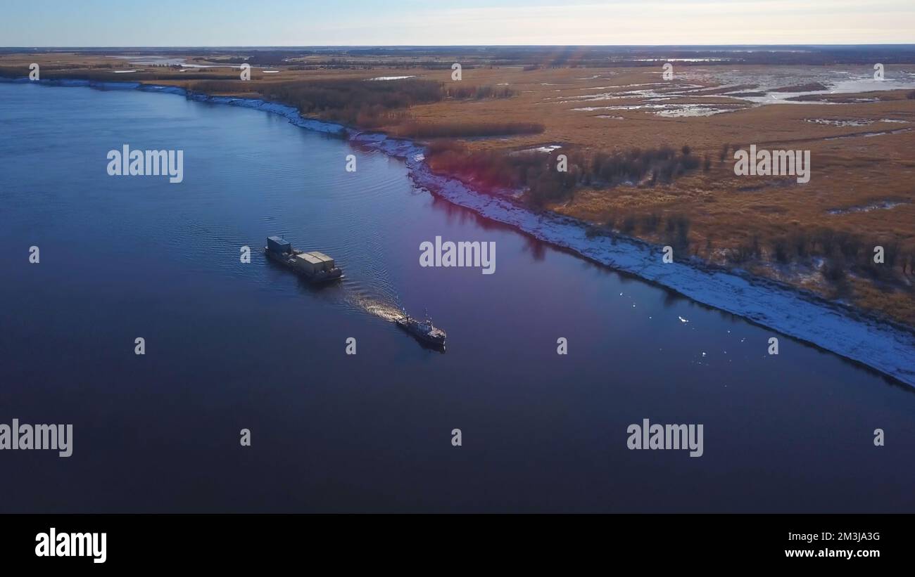 Aerial view of shipping barge transporting goods up the river. Clip ...