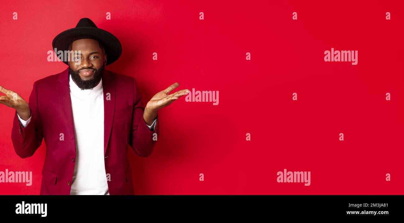 Clueless and unbothered Black man shrugging with indifferent look, dont ...