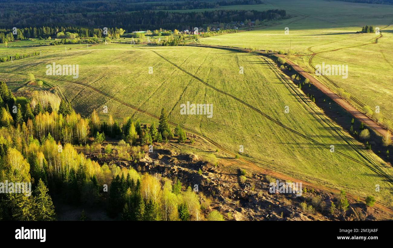 Rural landscape with a tiny village, green fields and trees. Clip ...