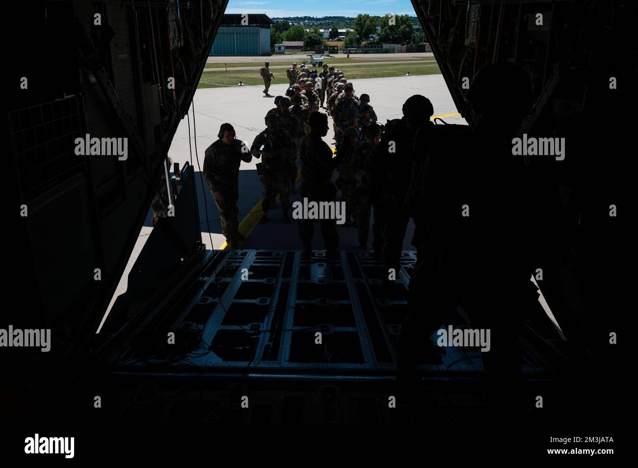 Members of the U.S. and German militaries board a U.S. Air Force MC-130 ...