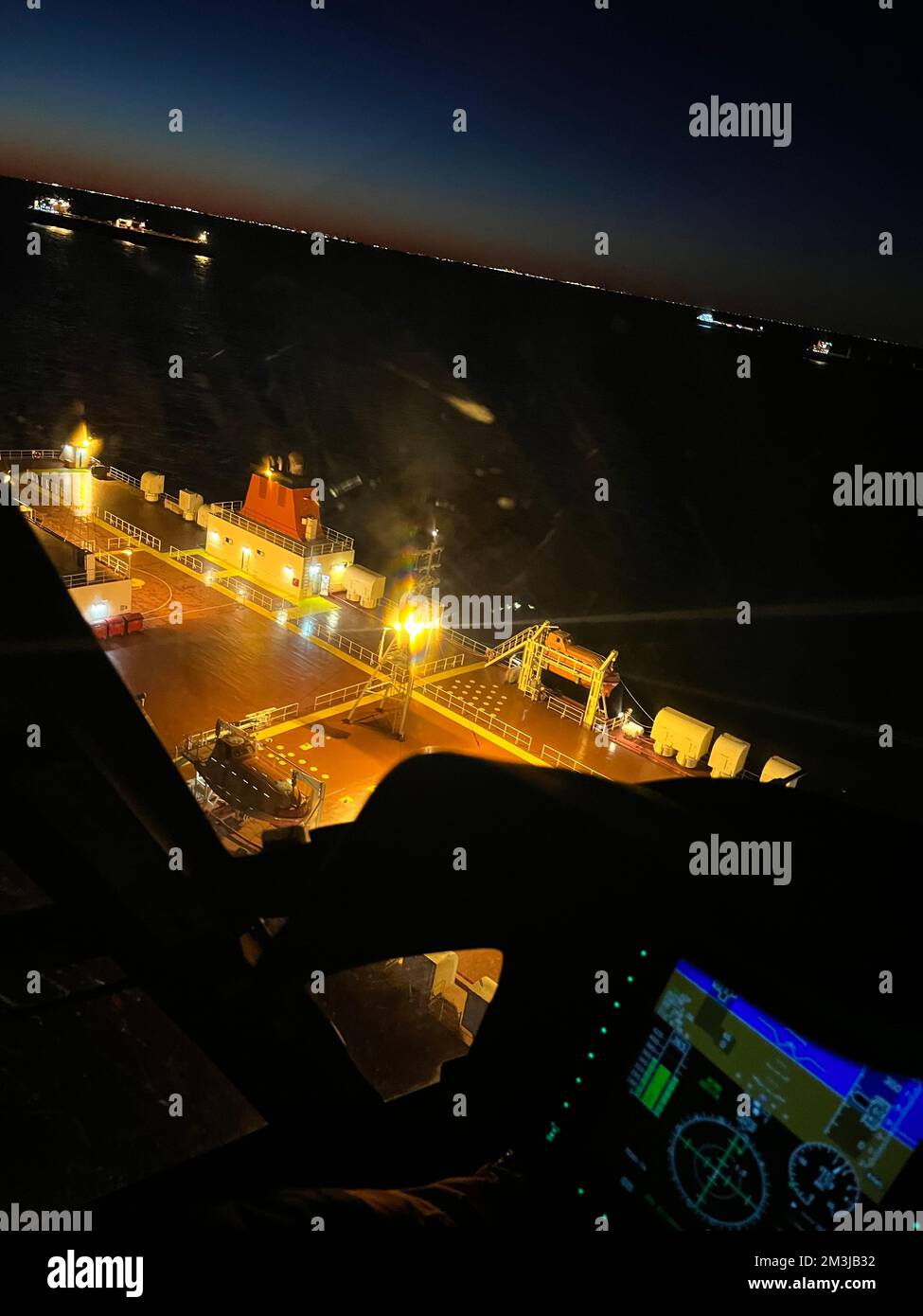 A Coast Guard Air Station Houston MH-65 Dolphin helicopter crew ...
