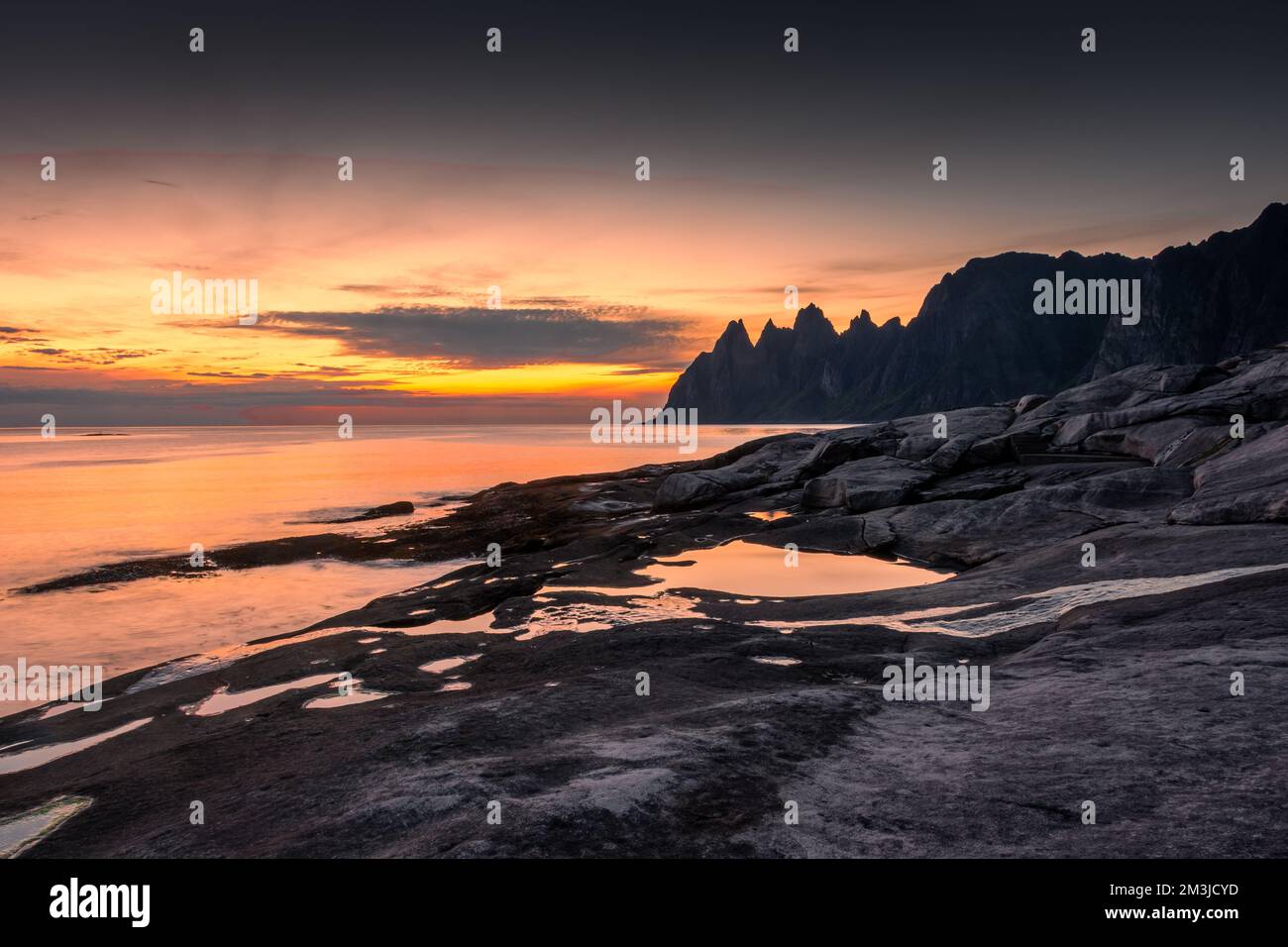 Stunning midnight sun over the Tungeneset (Devil's Teeth) in Senja ...