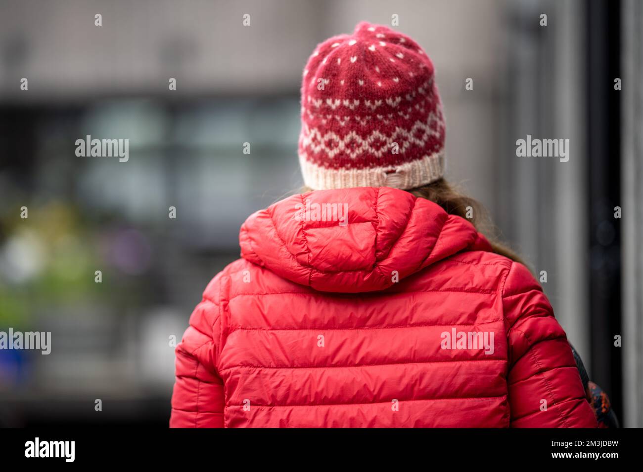 girl walking away from the camera in winer wearing a jacket in new york ...
