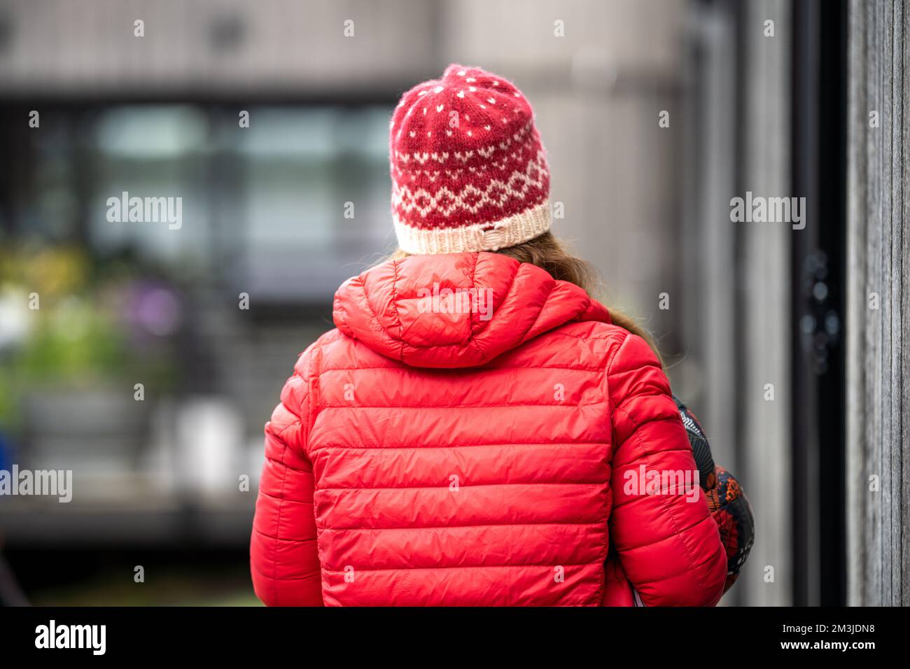 girl walking away from the camera in winer wearing a jacket in new york ...