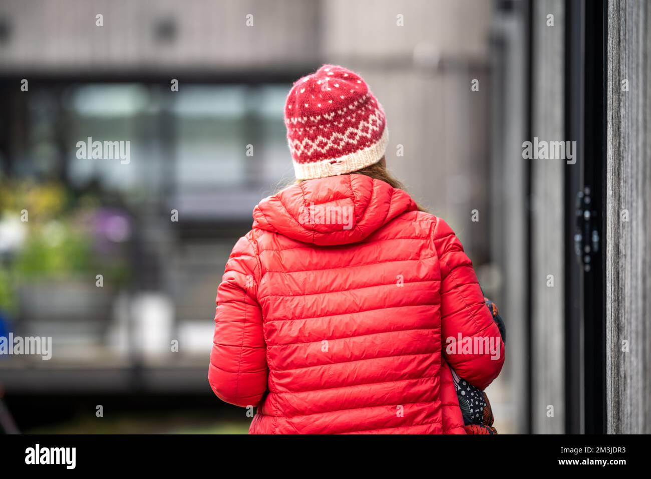 girl walking away from the camera in winer wearing a jacket in new york ...