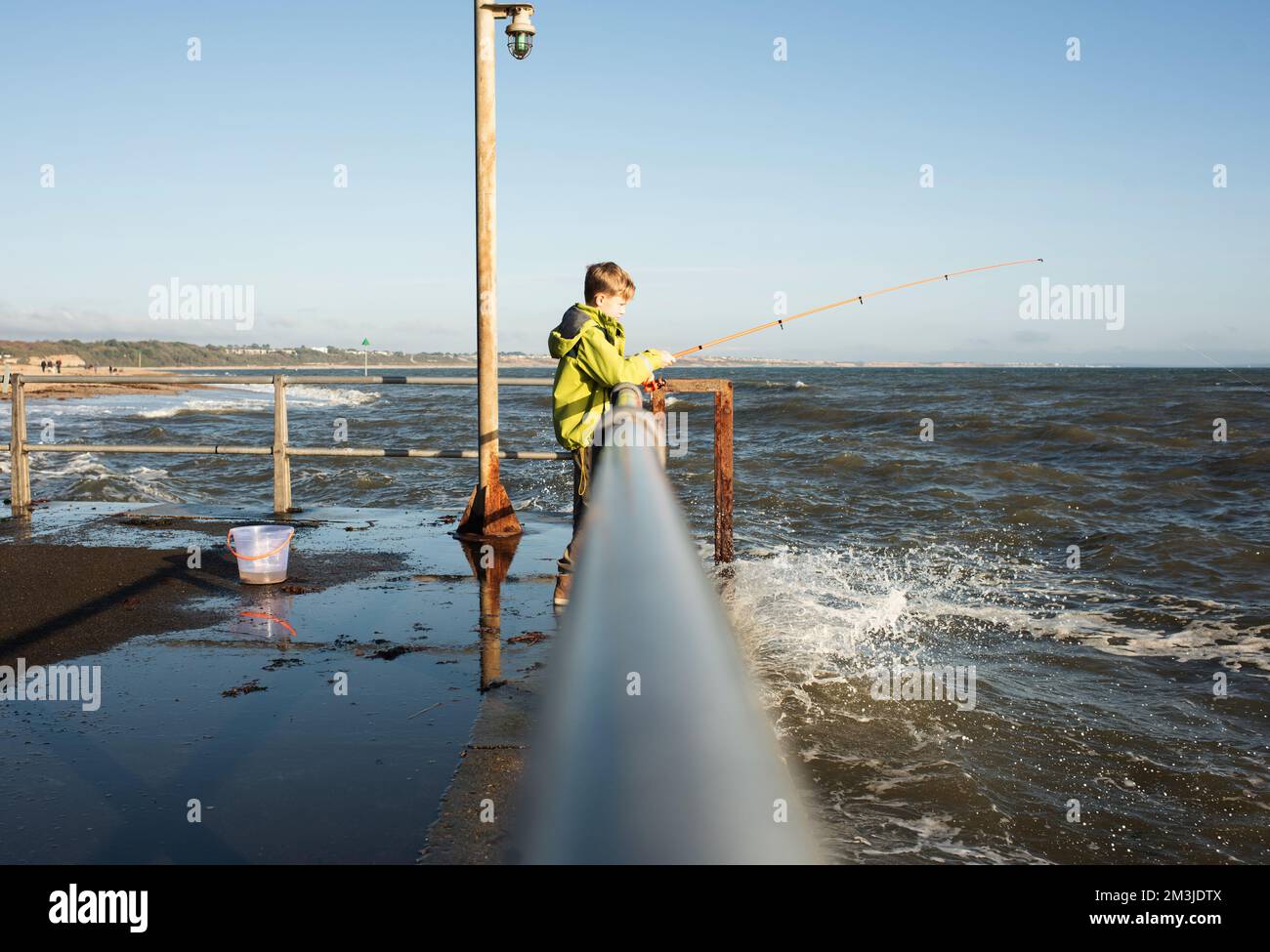 boy with his fishing net fishing for crabs in the sea Stock Photo - Alamy