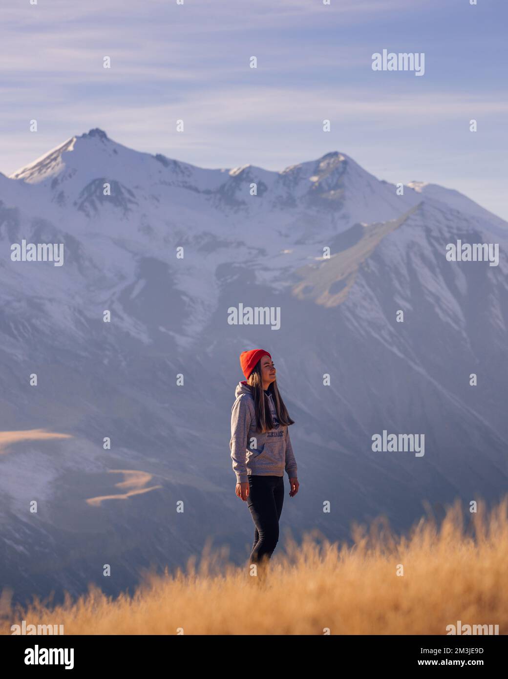 Girl in red hat portrait in mountains Stock Photo - Alamy