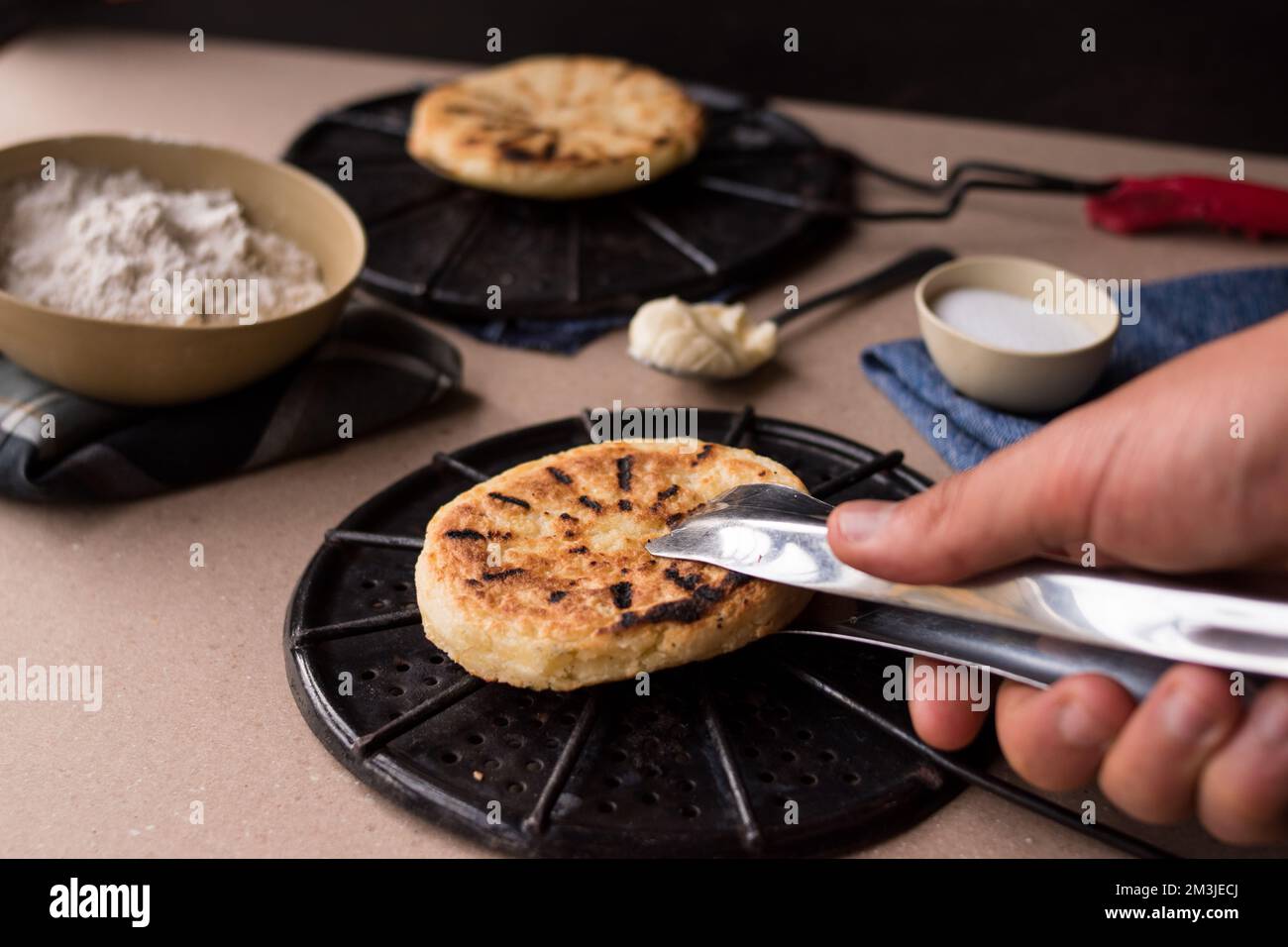 Hand taking an "Arepa" Clombian traditional food Stock Photo - Alamy
