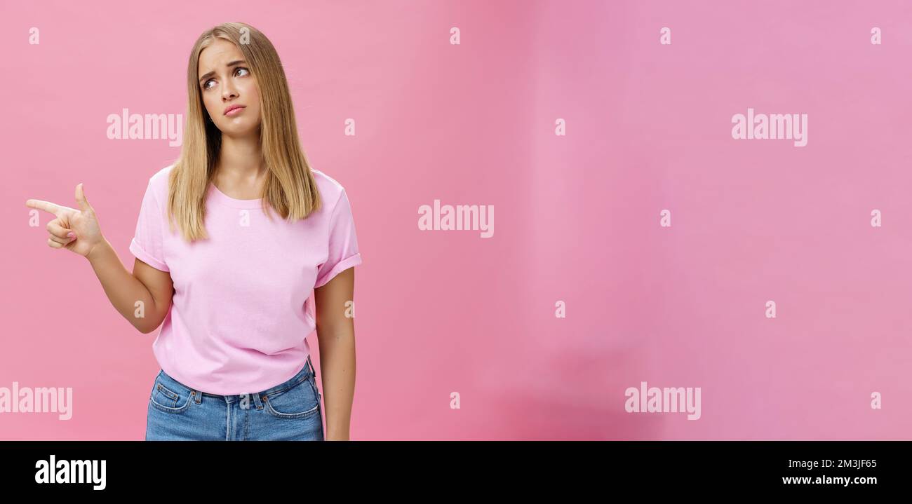 Envy upset cute young european woman with tanned skin and fair hait ...