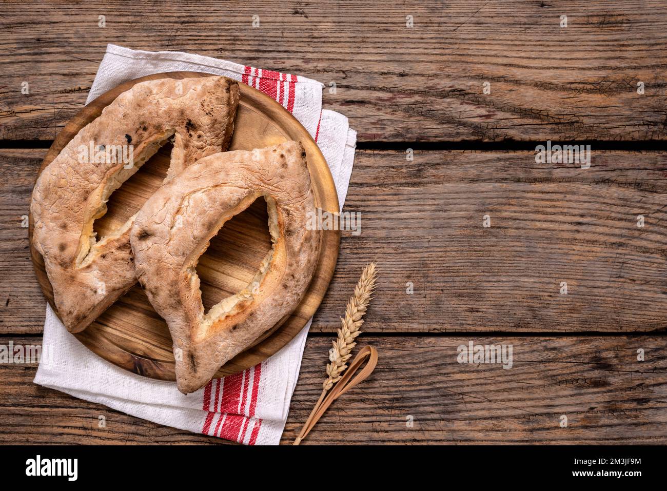 Serbian traditional homemade baked buns (lepinja) and ear of ripe wheat ...