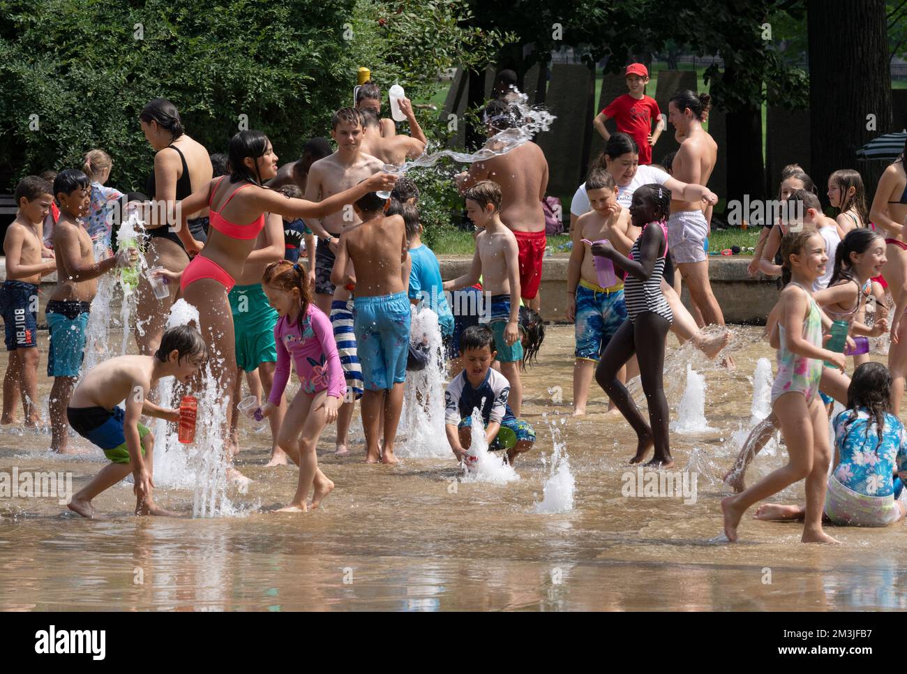 People cool off at a splash pad as temperatures go above 30C, Wednesday ...
