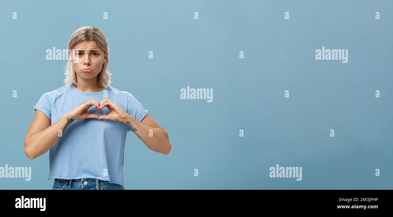 Heart being broken. Sad and gloomy heartbroken girl with blond hair ...