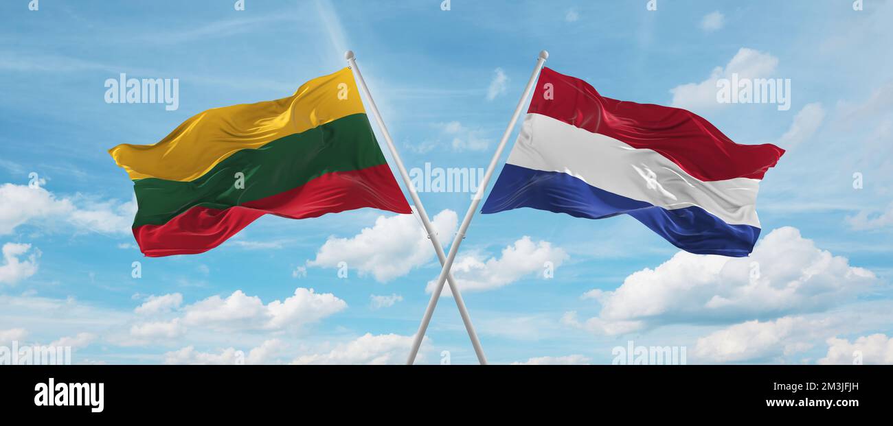 two crossed flags netherlands and Lithuania waving in wind at cloudy ...