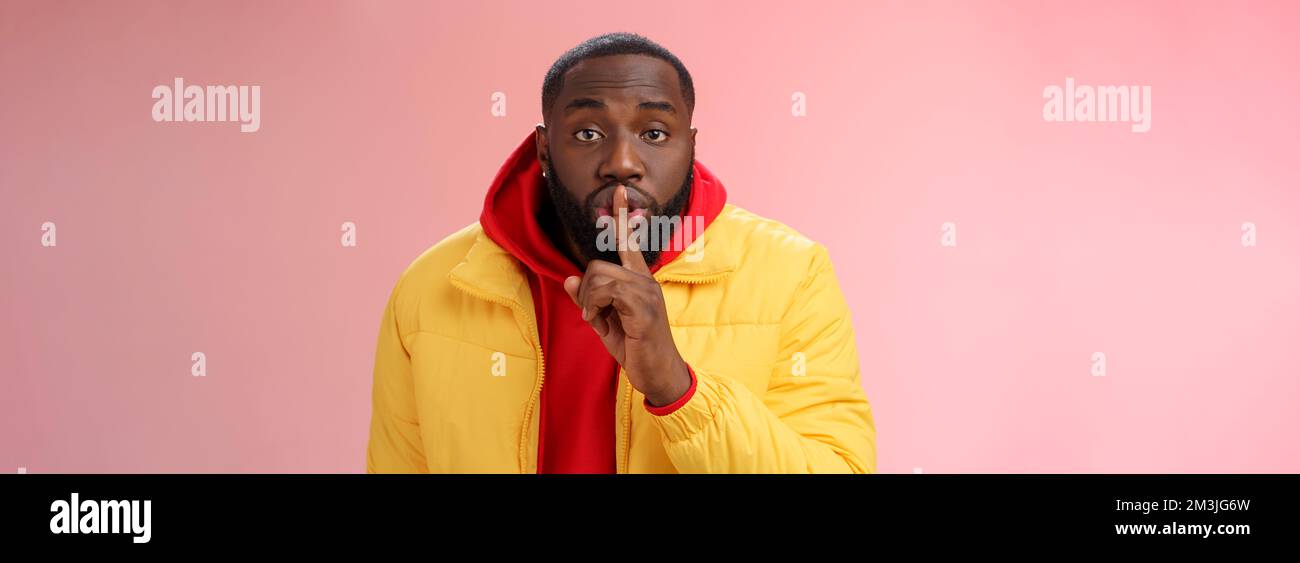 Waist-up serious-looking african-american bearded man in yellow jacket ...