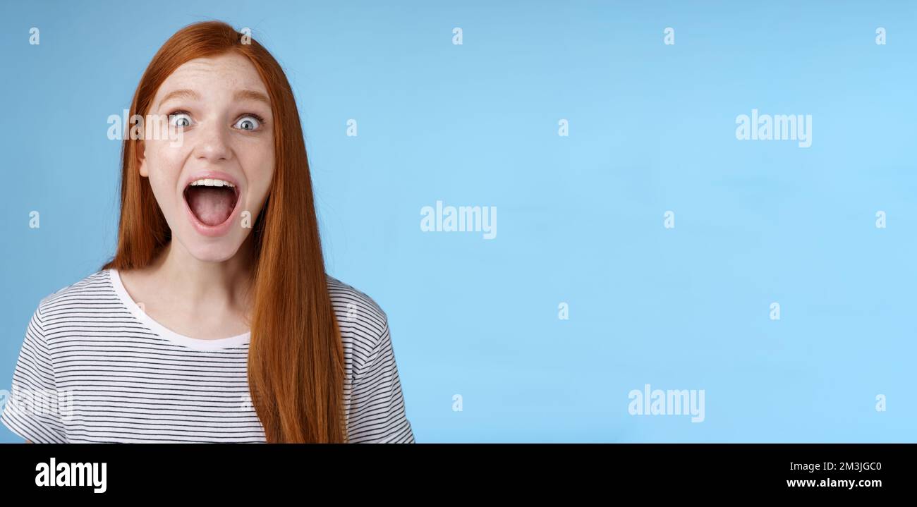 Amused thrilled enthusiastic surprised good-looking redhead girl wide ...