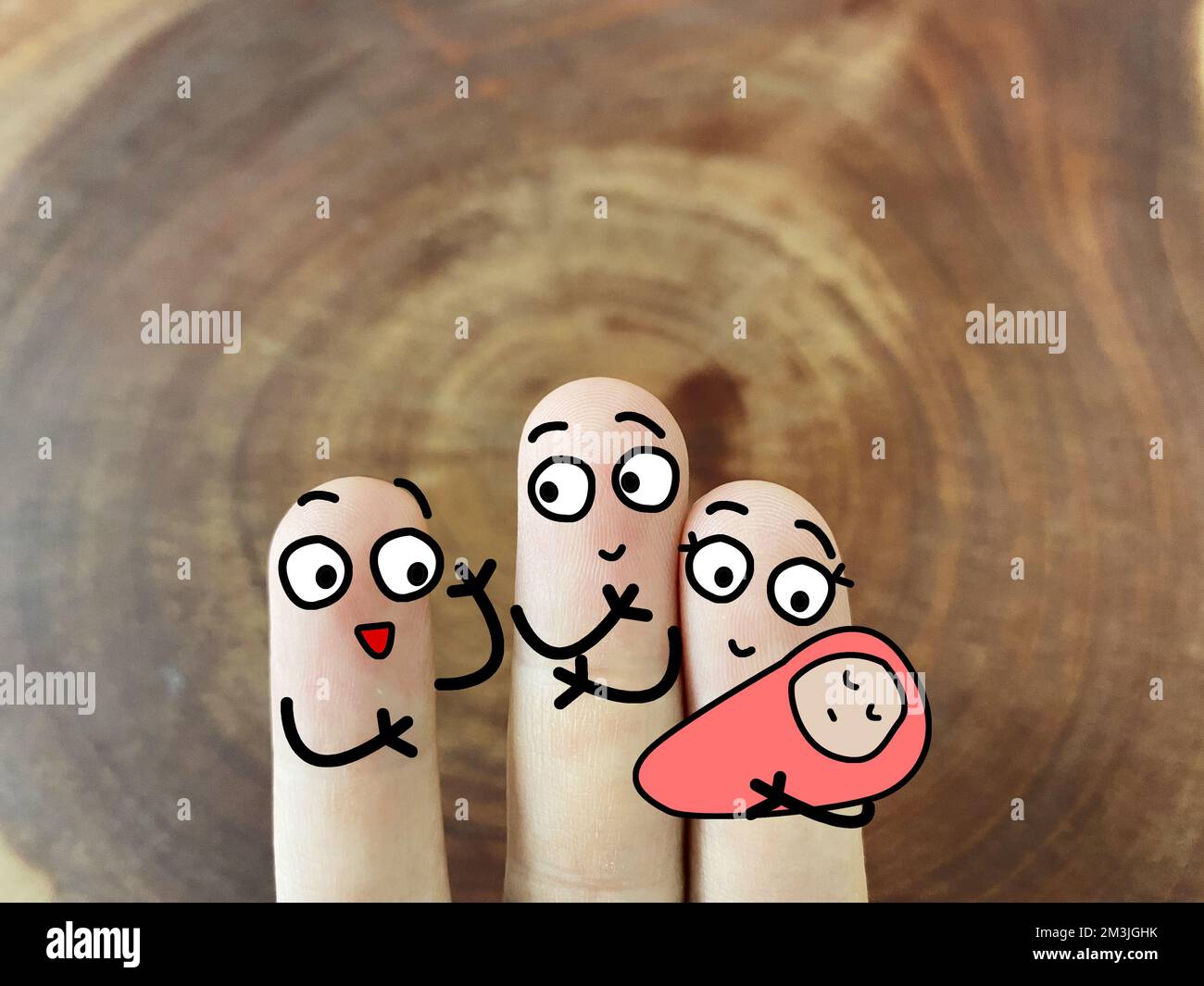 Three fingers are decorated as three person. One of them is holding a ...