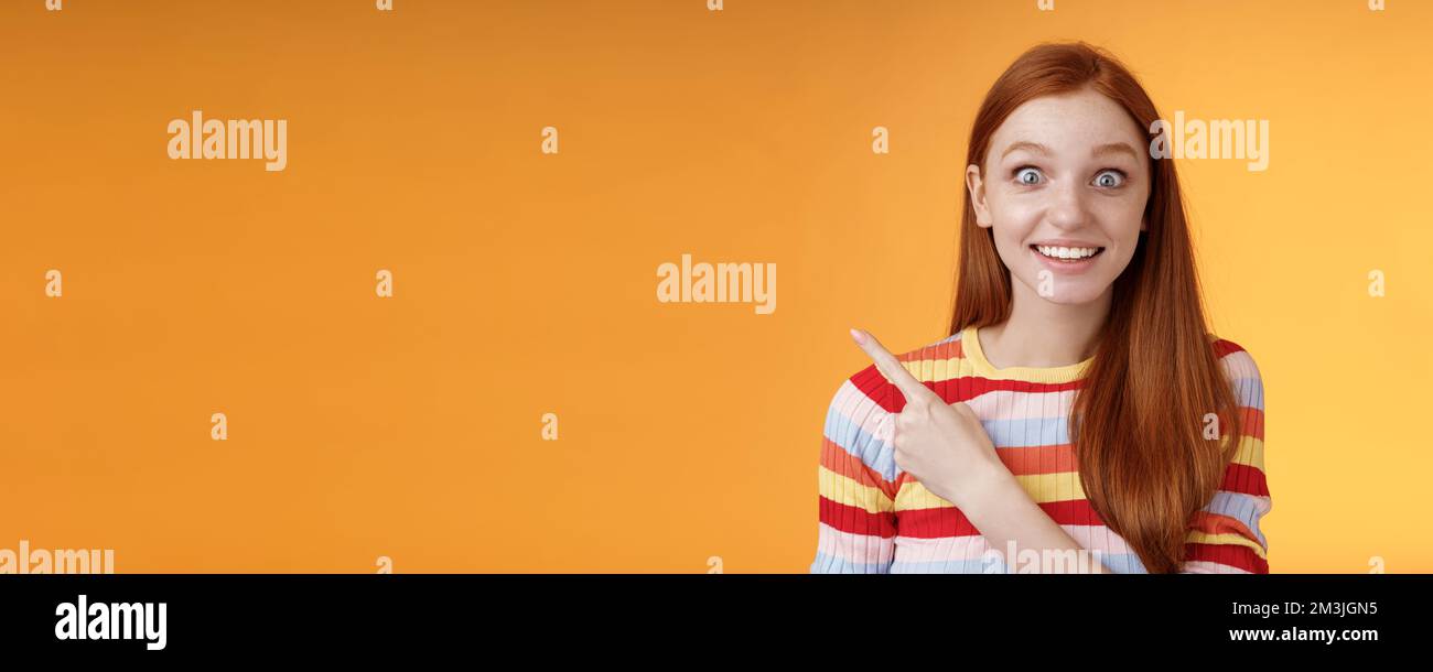 Excited thrilled good-looking young silly redhead girl surprised pop ...